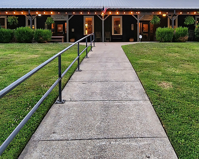 The welcoming path to catfish paradise glows at dusk, with string lights twinkling like fireflies guiding hungry travelers to their reward.