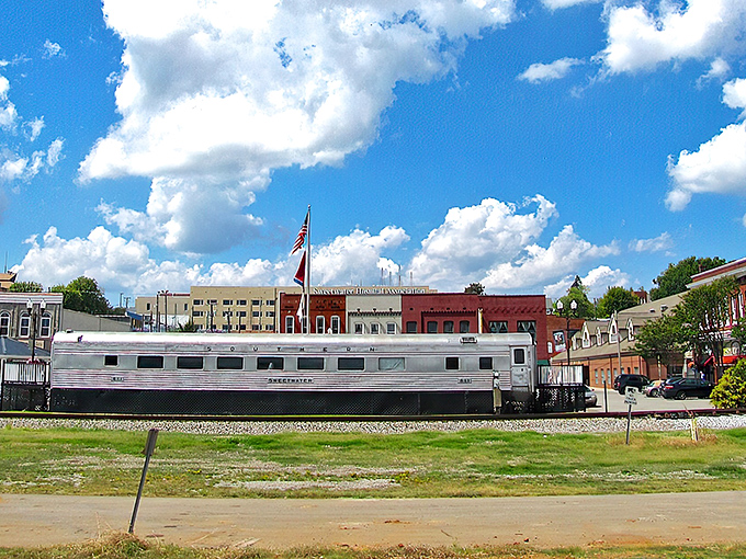 The vintage silver railcar stands sentinel over Sweetwater's historic downtown, a gleaming reminder of the town's railroad roots.