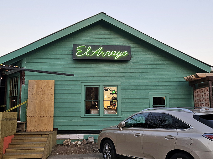 El Arroyo's mint-green exterior might be understated, but that neon sign promises the flavor fiesta waiting inside. Texas charm at its finest!