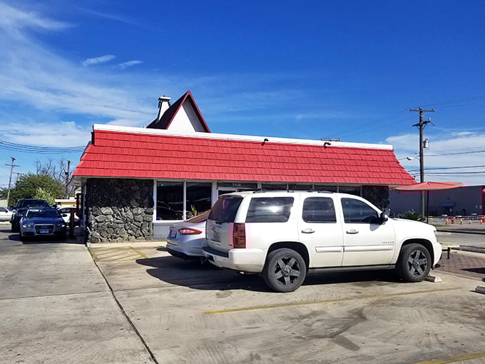 The iconic red-roofed A-frame of Griff's stands like a beacon of burger hope against the Texas sky. Architectural fast food poetry in motion.