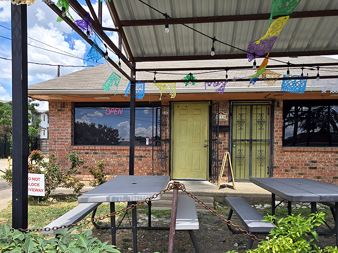 That cheerful yellow door isn't just an entrance—it's a portal to flavor town, complete with festive papel picado flags overhead.