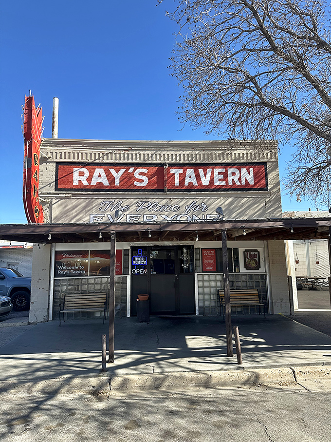 The iconic red neon sign of Ray's Tavern stands proudly against the Utah sky, beckoning hungry travelers like a desert lighthouse for the famished.