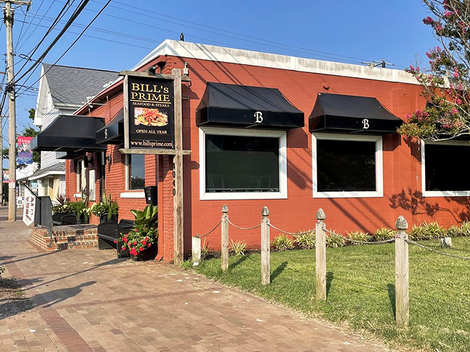 The brick-red exterior of Bill's PRIME stands like a culinary lighthouse on Chincoteague Island, beckoning hungry travelers with promises of seafood treasures within.