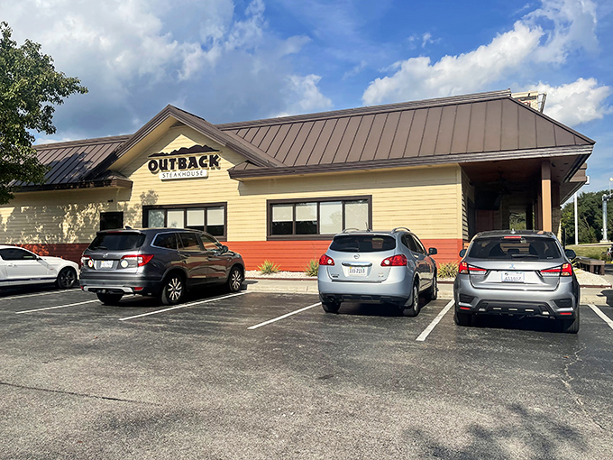 The Outback Steakhouse exterior stands proudly against Virginia's blue skies, promising Australian-themed delights in the heart of Christiansburg.