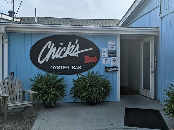 The iconic blue exterior of Chick's Oyster Bar beckons seafood lovers like a coastal lighthouse for the hungry and thirsty.