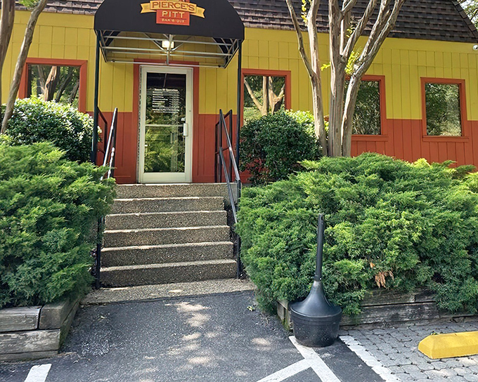 The unmistakable yellow and orange exterior of Pierce's stands out like a barbecue beacon, promising smoky delights within these vibrant walls.