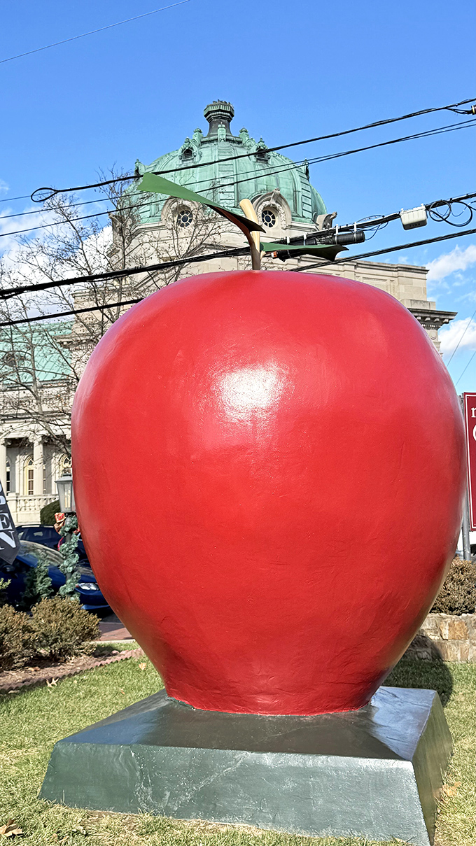 The crimson giant stands proudly against Winchester's historic skyline, like a fruit that escaped from a giant's picnic basket.