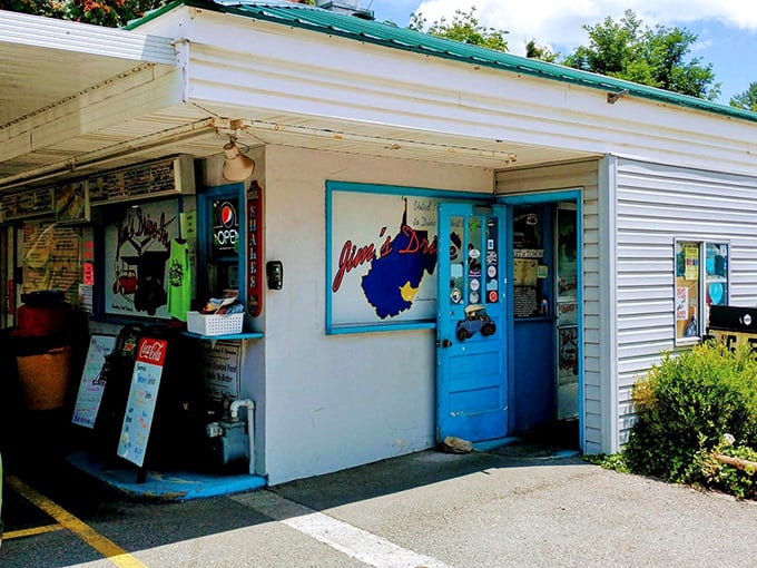 The unassuming white exterior with that iconic blue door is like finding a treasure map where X marks the spot for burger paradise.