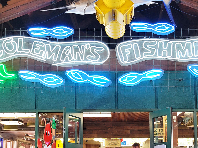 The iconic neon sign at Coleman's Fish Market glows like a beacon for seafood lovers. Those blue fish swimming around the name? Pure West Virginia magic.