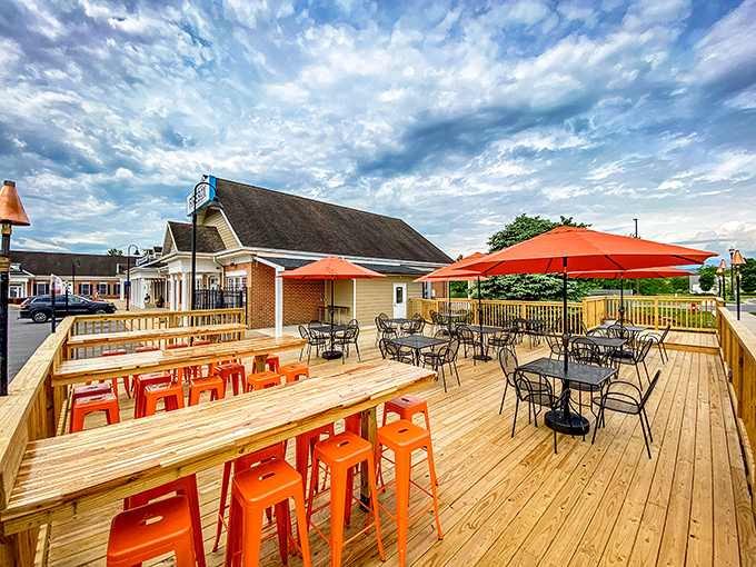 The outdoor deck at Firebox55 is where barbecue dreams come true, with bright orange seating that's as vibrant as the flavors waiting inside.