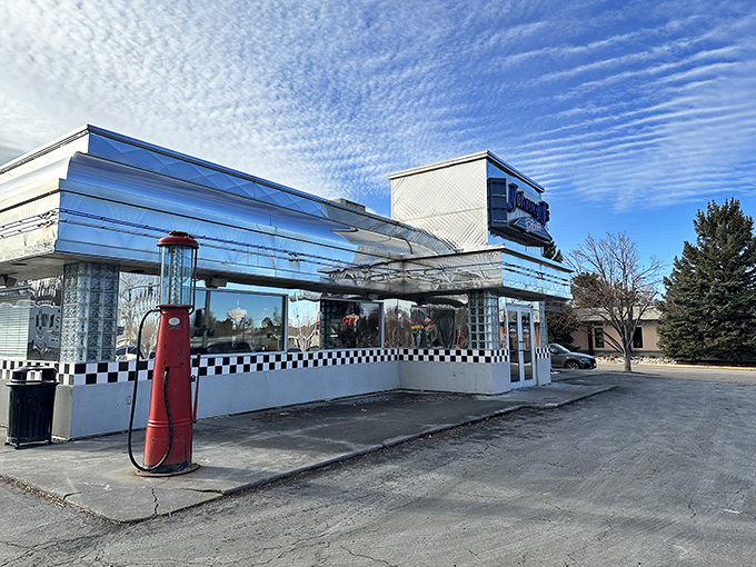 The gleaming chrome exterior of Johnny J's stands like a time machine in Casper, beckoning hungry travelers with its classic blue signage and checkerboard trim.