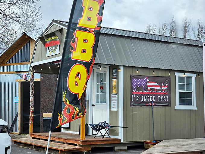 The BBQ flag waves proudly outside this unassuming barn-like structure, where smoke signals beckon hungry travelers to Rexburg's hidden gem.