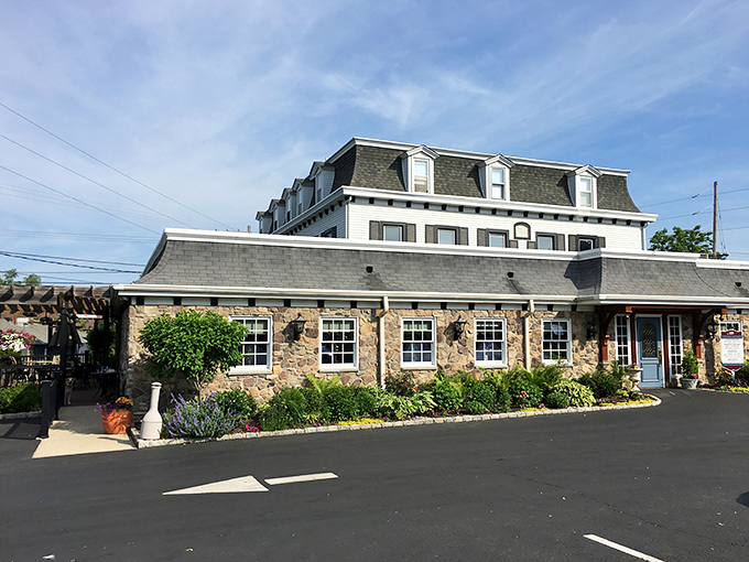 The historic fieldstone fa&ccedil;ade of Spring House Tavern stands proudly against a blue Pennsylvania sky, its centuries-old charm immediately transporting visitors to another era.