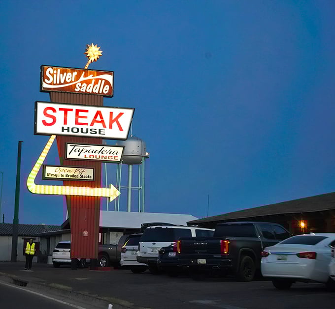 The iconic Silver Saddle sign glows against the Arizona twilight, a neon beacon promising carnivorous delights to hungry travelers on Benson Highway.