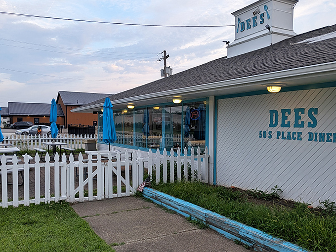The classic blue-and-white exterior of Dee's beckons like a time machine disguised as a diner. That white picket fence isn't just charming&mdash;it's practically a promise of comfort food ahead.