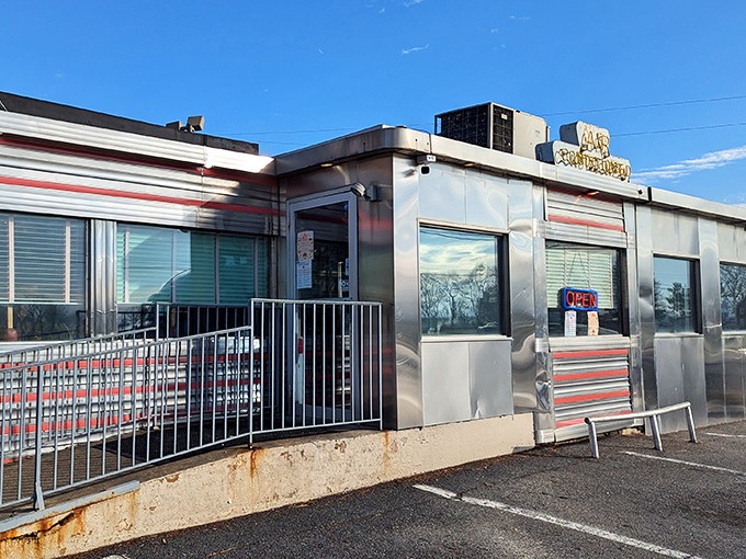 Classic Americana gleams in the Pennsylvania sunshine. The Route 30 Diner's stainless steel exterior promises timeless comfort inside those red-striped walls.