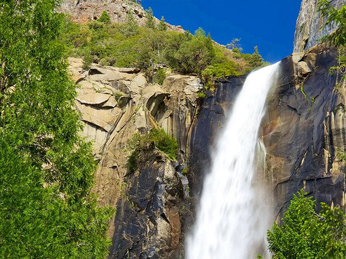 Nature's perfect curtain call: Bridalveil Fall cascades 620 feet down sheer granite cliffs, creating a misty spectacle that dances with the afternoon light.