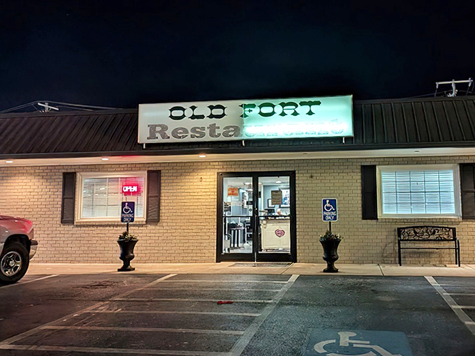 The neon glow of Old Fort Restaurant beckons hungry travelers like a lighthouse for breakfast sailors navigating the seas of morning hunger.