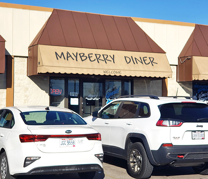 The welcoming awning beckons like a siren song, promising comfort food that'll make you forget your troubles.