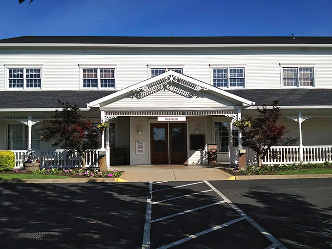 The classic white clapboard exterior of Amish Door Restaurant welcomes visitors like a warm hug from a grandmother you never knew you had.