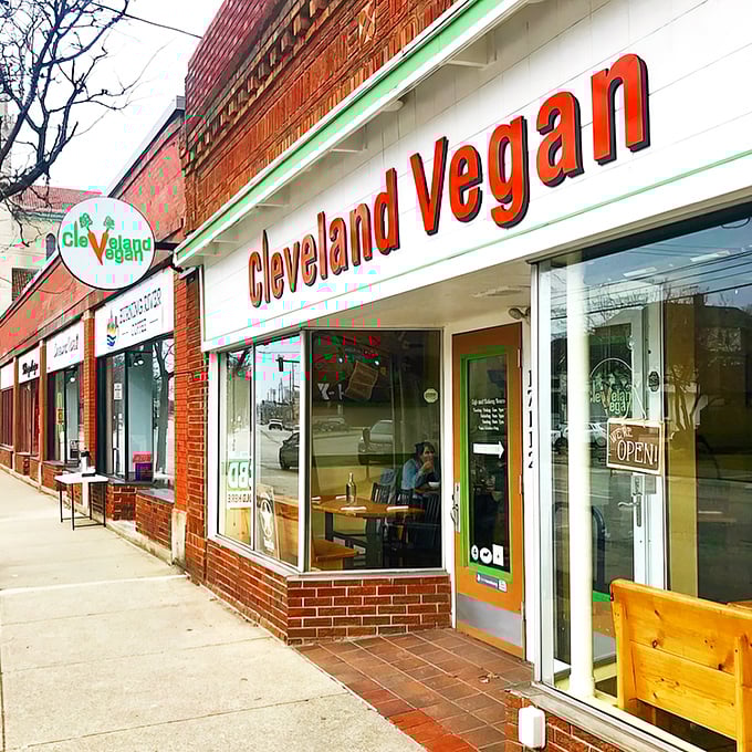 The iconic red signage with green trim beckons hungry passersby into a world where plant-based means anything but boring.
