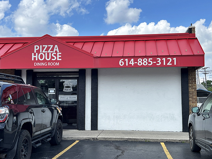 The iconic red roof of Pizza House stands out like a beacon for hungry Columbus residents, promising pizza perfection behind those modest doors.