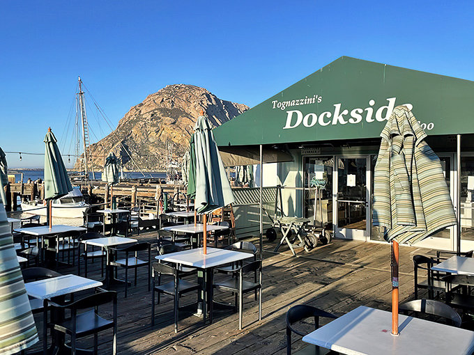 Morro Rock stands guard like a culinary sentinel as diners enjoy the simple pleasure of fresh seafood on Tognazzini's wooden deck. Paradise found.