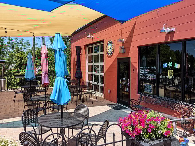 The vibrant red exterior beckons like a culinary lighthouse, with colorful umbrellas promising shade for your feast and flowers adding a touch of Florida charm.