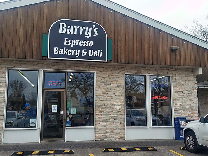 The wooden gabled roof and stone facade of Barry's stands like a beacon of breakfast hope against Eugene's forested hills.