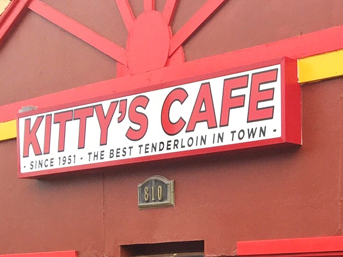 The fire-engine red exterior of Kitty's Cafe stands like a culinary lighthouse, promising "the best tenderloin in town" since 1951.