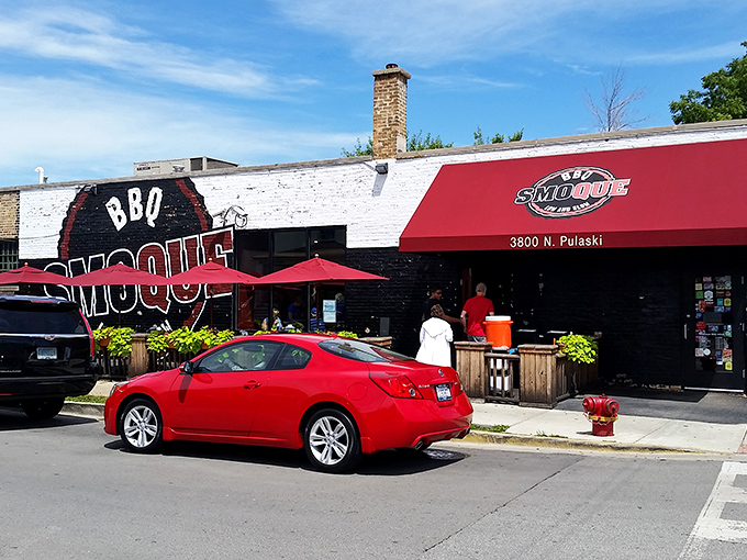 The iconic red and black exterior of Smoque BBQ stands like a beacon for barbecue pilgrims. That "Low and Slow" motto isn't just clever marketing&mdash;it's a solemn promise.