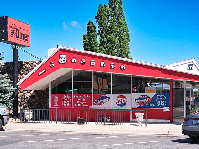 The cherry-red exterior of Goldies Route 66 Diner stands out like a beacon on the Mother Road, promising nostalgic delights and hearty comfort food within.