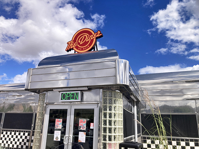 The gleaming silver exterior of Diner on Main catches the desert sun like a time-traveling spaceship that landed with burgers.