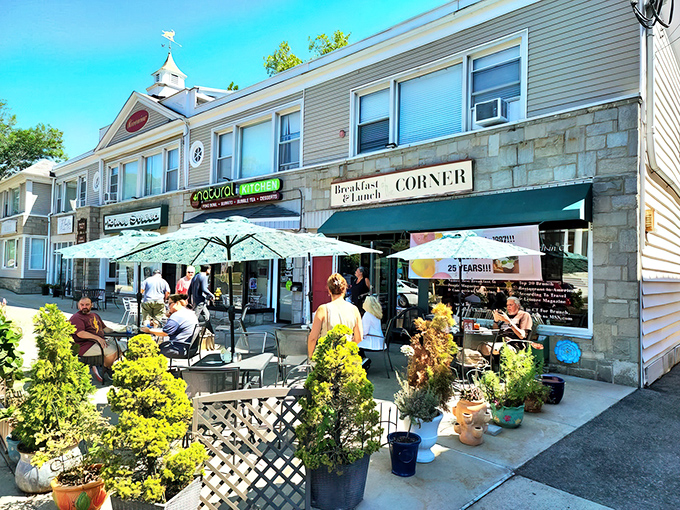 Outdoor dining with umbrellas and planters – because sometimes your eggs need a little fresh air too.