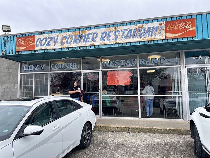 The blue exterior of Cozy Corner Restaurant stands as a humble temple to Memphis BBQ greatness, promising smoky delights within those unassuming walls.