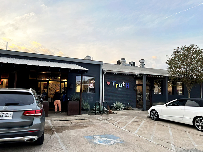 Truth's navy blue exterior with its colorful lettering doesn't scream "barbecue royalty," but that's Texas for you&mdash;the best spots often hide in plain sight.