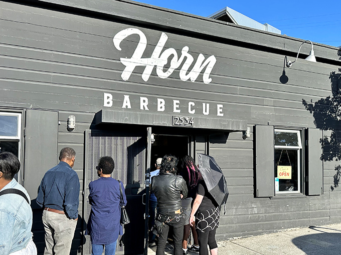 Lines form early outside Horn Barbecue, where patient meat devotees gather like concert fans waiting for backstage passes to flavor town.