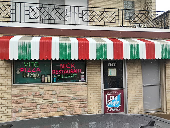 The iconic red, white, and green striped awning of Vito & Nick's stands as a beacon of hope for hungry South Siders seeking pizza salvation.