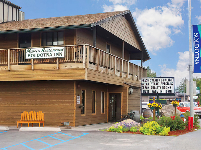 The unassuming wooden exterior of Mykel's Restaurant at Soldotna Inn belies the culinary treasures within. Alaska's best-kept secret hides in plain sight.
