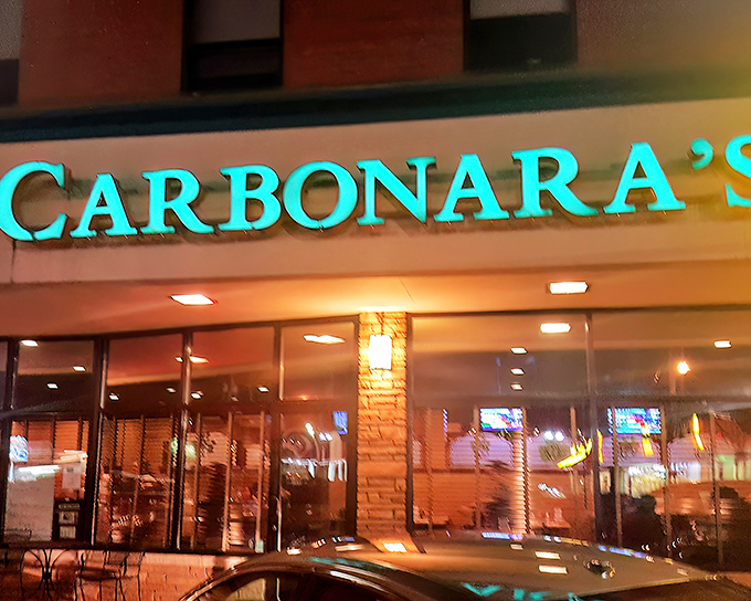 Nighttime at Carbonara's transforms the modest exterior into something magical, like Clark Kent stepping into a phone booth. The glow promises comfort inside.
