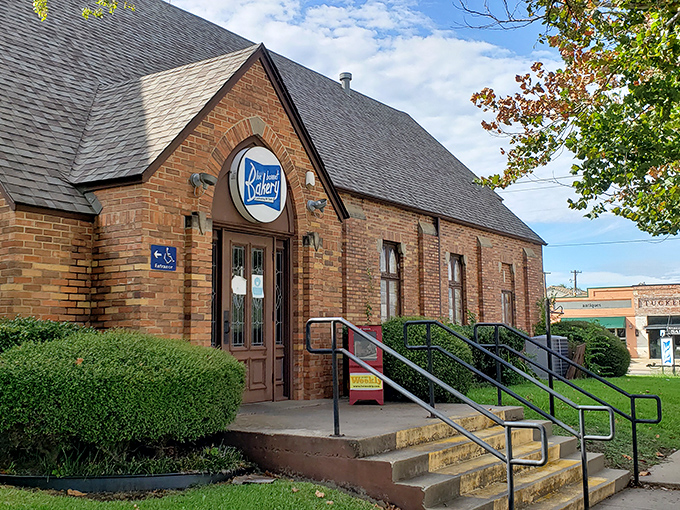 The brick exterior of Blue Bonnet Bakery stands like a temple to flour and sugar, promising sweet salvation inside since 1934.