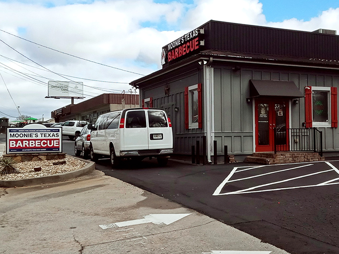 The unassuming gray exterior with bold red signage is like a secret handshake &ndash; those who know, know. BBQ paradise awaits inside.