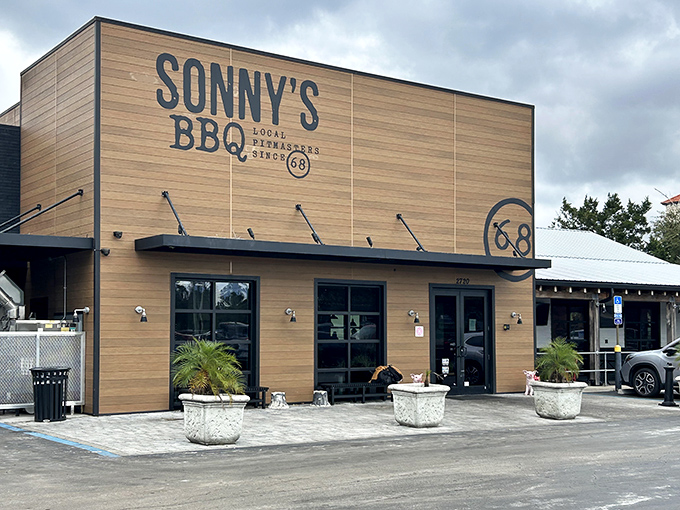 The modern rustic charm of Sonny's exterior hides a temple of slow-smoked perfection. Those concrete planters aren't just decorative&mdash;they're the gatekeepers to brisket paradise.