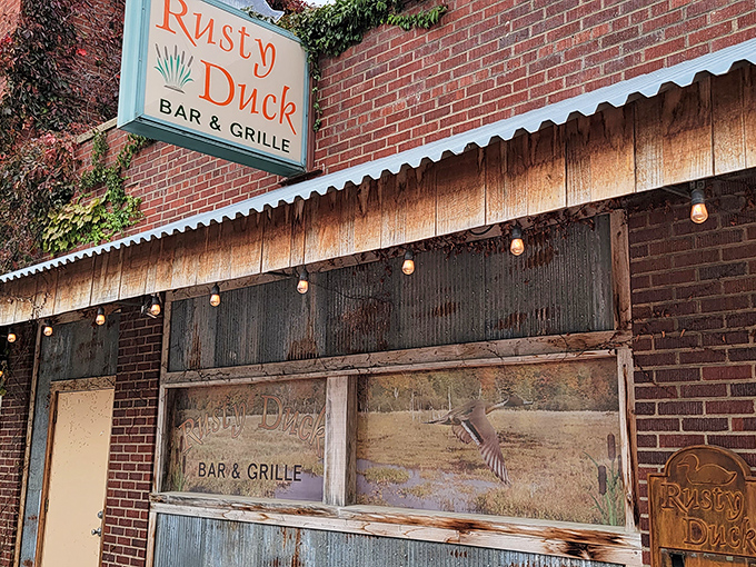 The Rusty Duck announces itself with rustic charm and twinkling lights that promise good times ahead on Main Street.