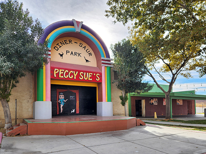 The jukebox-shaped entrance to Peggy Sue's stands like a technicolor mirage in the desert, promising relief for weary travelers and hungry road-trippers alike.