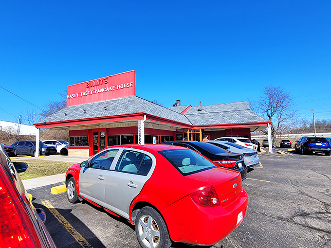 The iconic red exterior of Bunny's Hasty Tasty Pancake House glows like a beacon for breakfast lovers. No fancy frills, just the promise of honest-to-goodness comfort food.