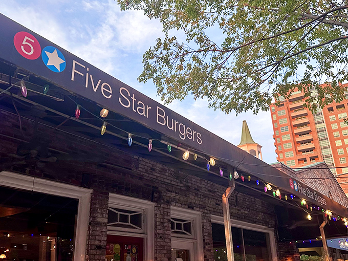 The welcoming entrance adorned with colorful lights promises the kind of burger experience that makes detours worthwhile.