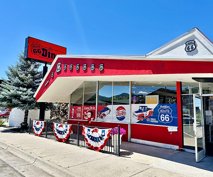 The cherry-red exterior of Goldies Route 66 Diner stands out like a classic Corvette against the Arizona sky, beckoning hungry travelers with promises of nostalgic delights.