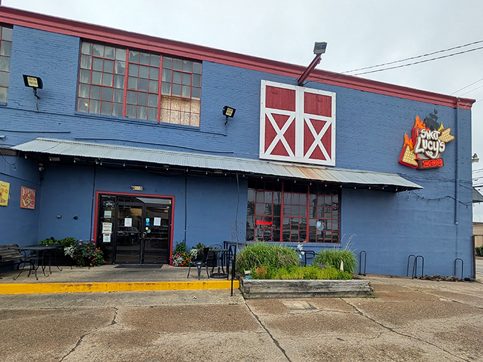 Sweet Lucy's distinctive blue building stands out like a beacon of hope for the hungry. Those stacked wood piles aren't just for show&mdash;they're flavor in waiting.