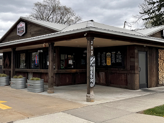 The rustic wooden exterior of Woodpile BBQ Shack promises no pretension&mdash;just serious smoke business happening inside those walls.